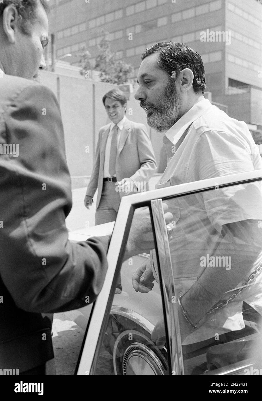 Convicted murderer Joseph Kallinger is escorted in handcuffs by police ...