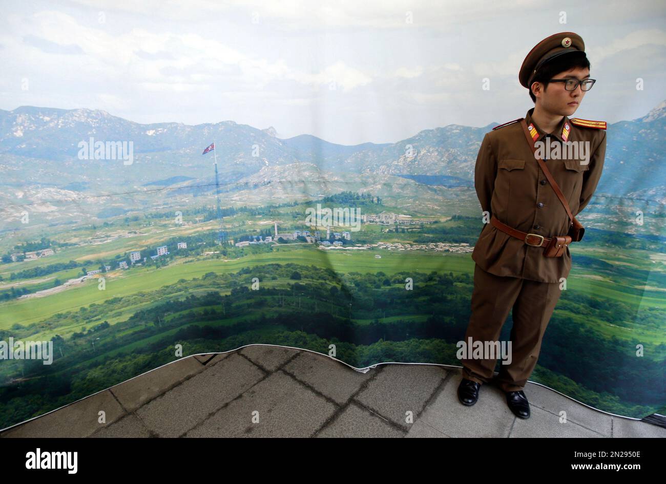 A man playing a role of a North Korean soldier stands in front of a ...