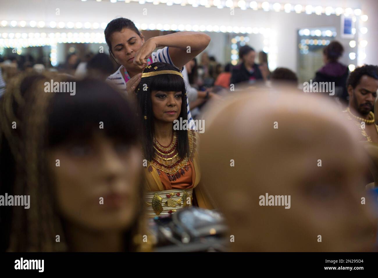 In this May 13, 2015 photo, a hairdresser styles a wig worn by ...