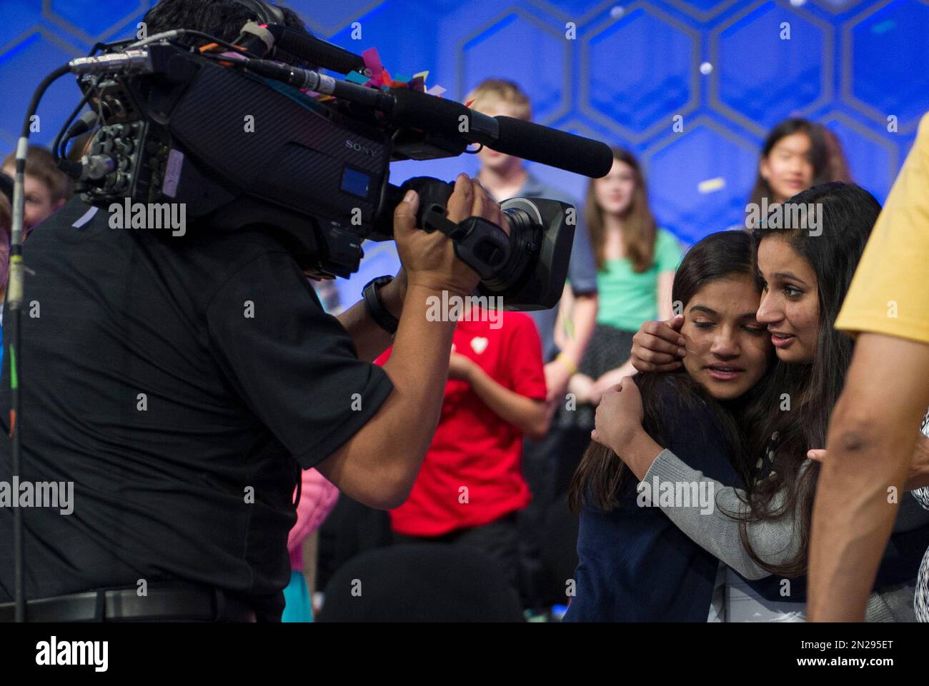 Vanya Shivashankar, 13, of Olathe, Ks., is hugged by her sister Kavya ...