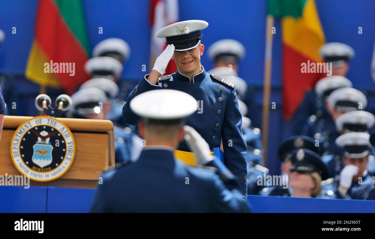Graduating Air Force Academy cadets salute as they receive their ...