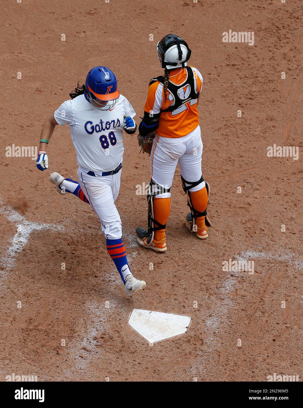 Floria's Bailey Castro (88) scores behind Tennessee catcher Annie ...
