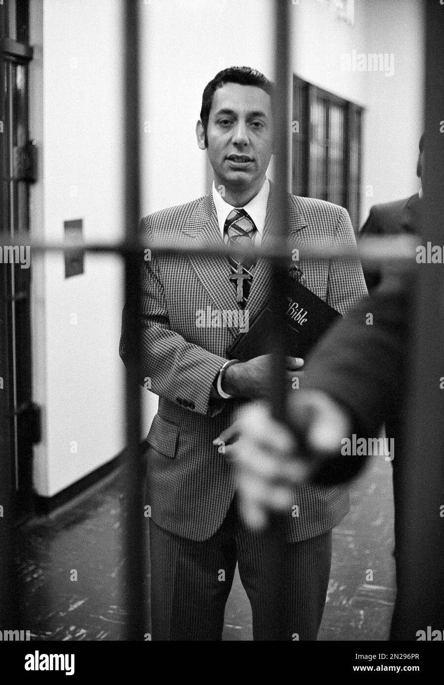 Joseph Kallinger of Philadelphia, his handcuffed wrists carrying a ...