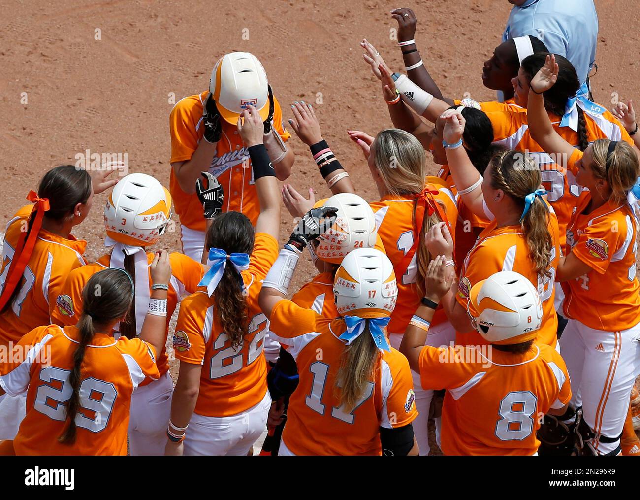 Tennessee's Megan Geer, top, is greeted by teammates at home plate ...