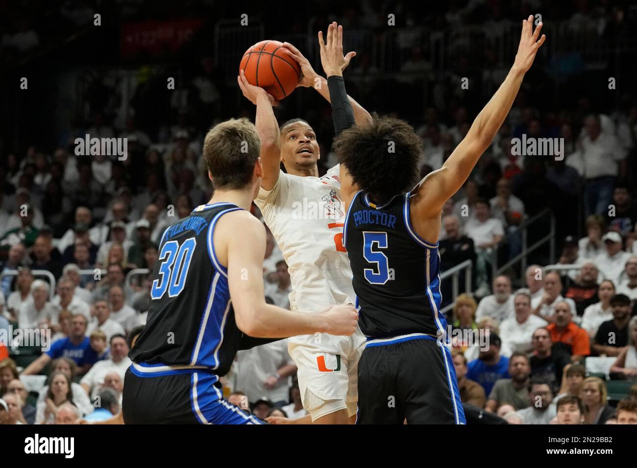 Miami guard Isaiah Wong (2) aims to score as Duke center Kyle ...
