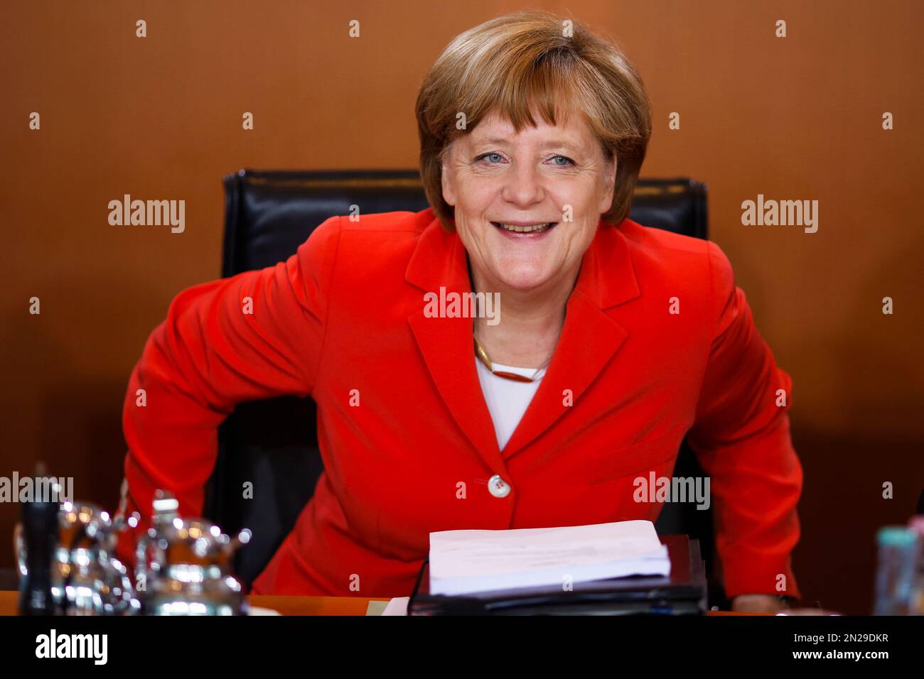 German Chancellor Angela Merkel smiles as she arrives for the weekly ...