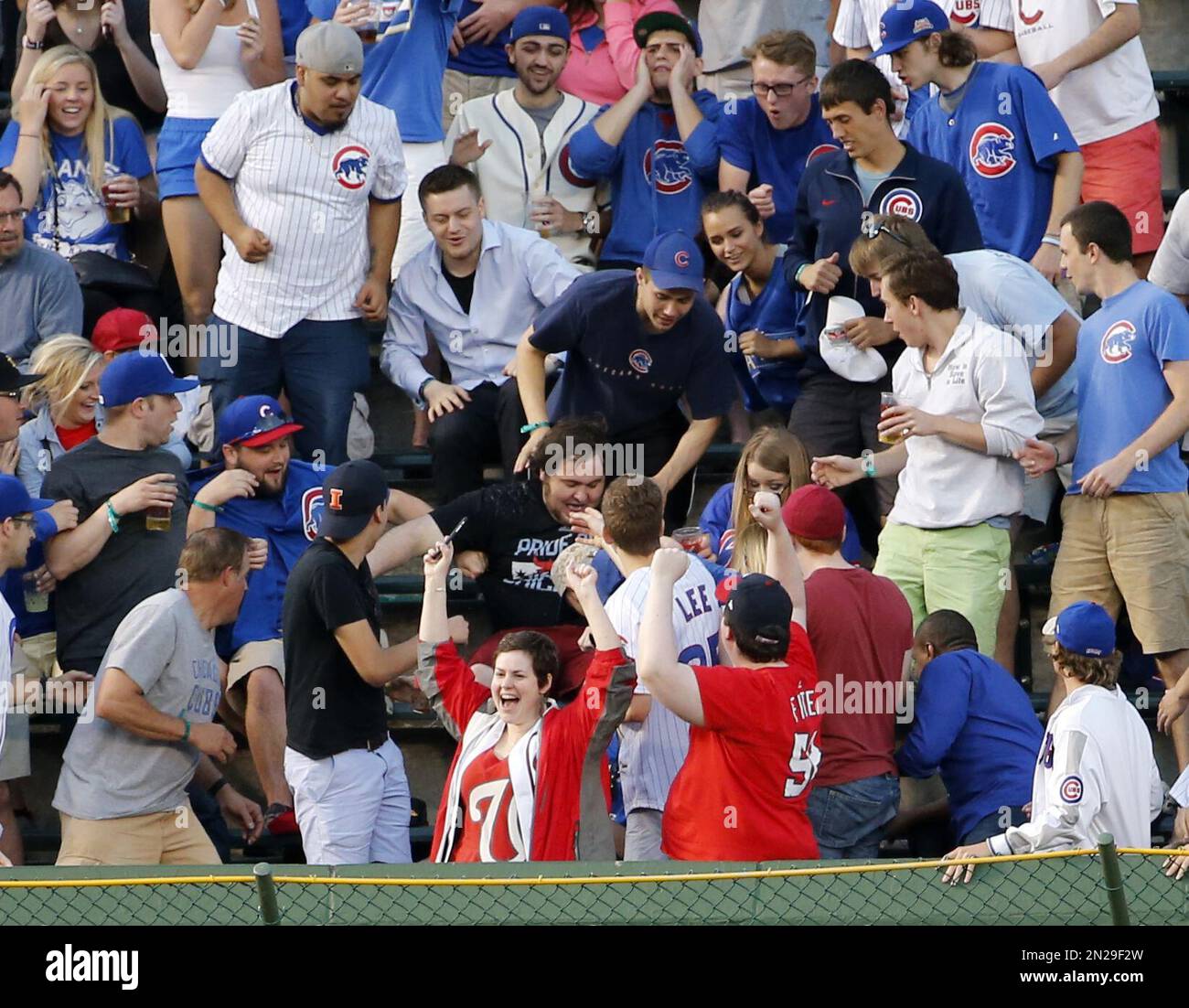 Two Washington Nationals' fans in the left field bleachers, celebrate ...