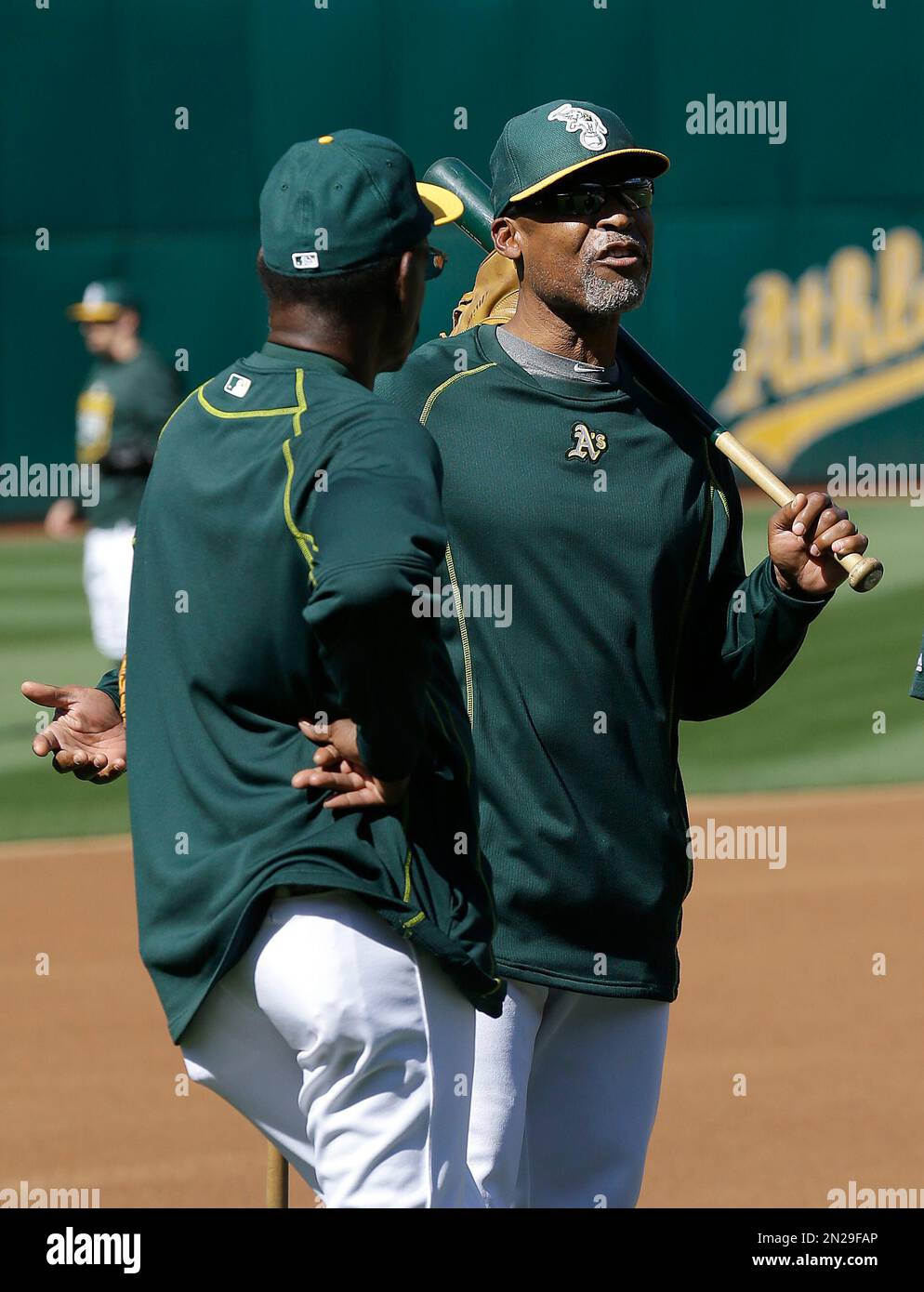 Oakland Athletics coach Ron Washington, left, talks with first base ...