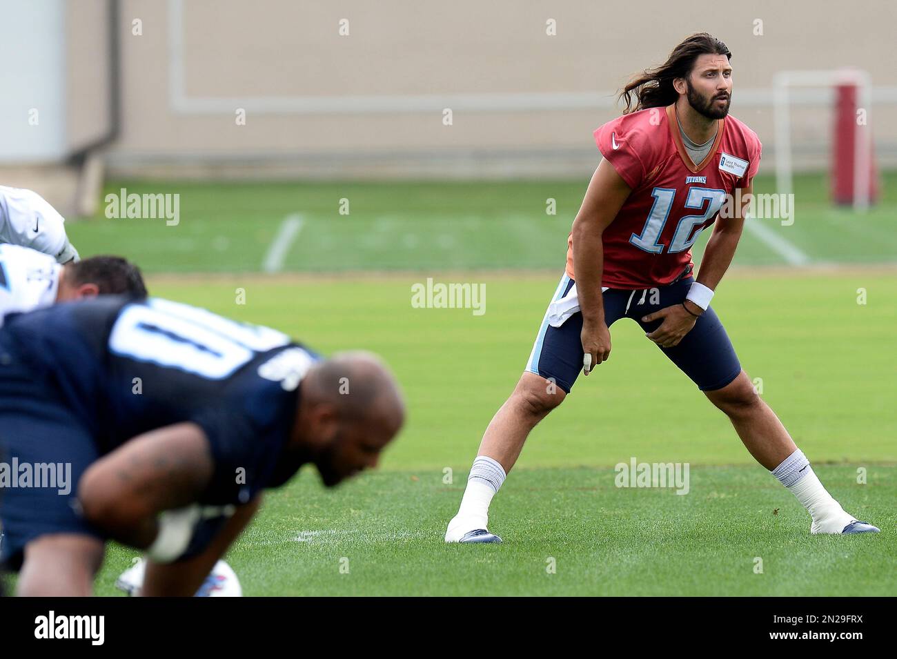 Tennessee Titans quarterback Charlie Whitehurst, right, stretches ...
