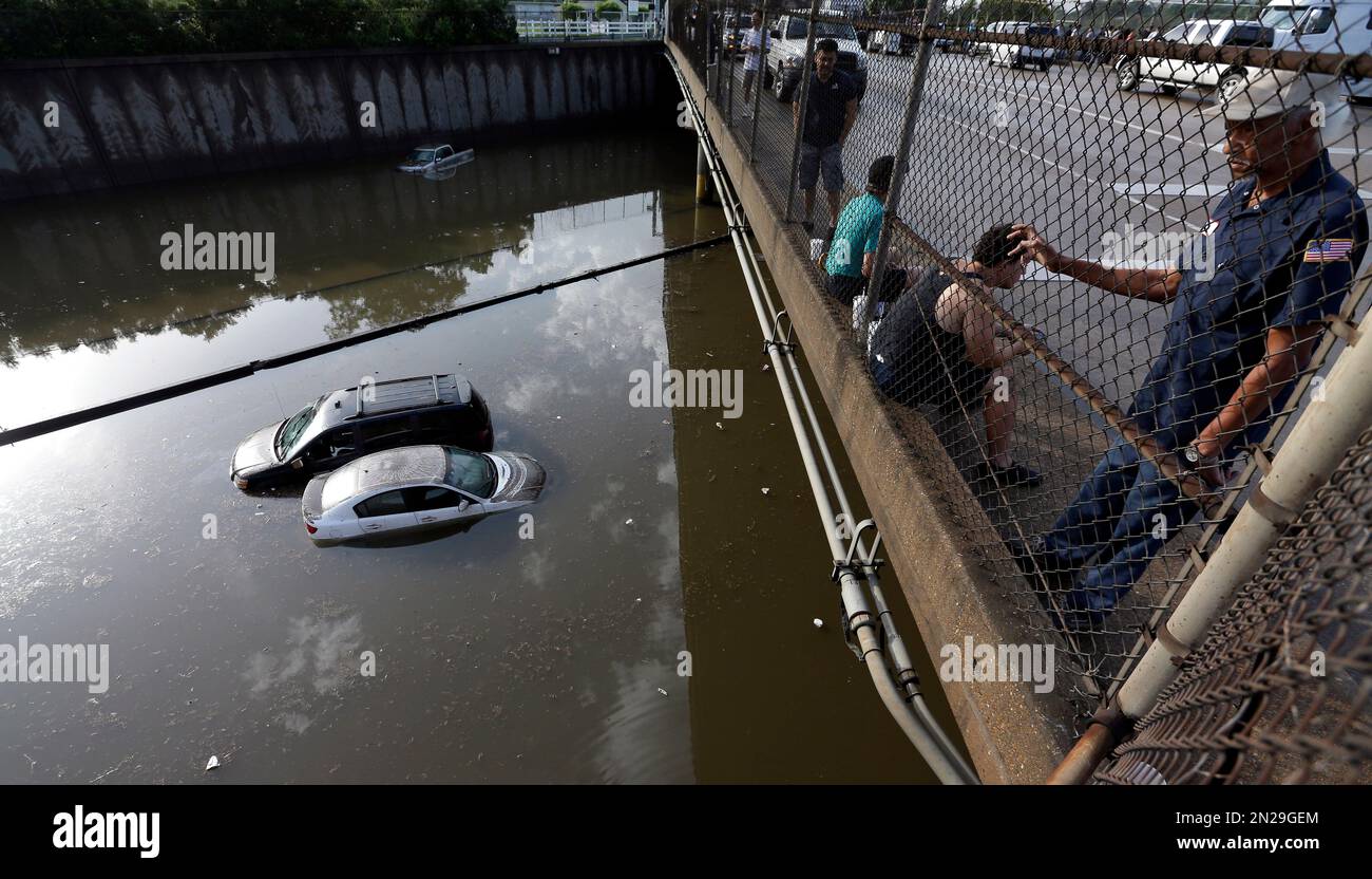 Cars sit in floodwaters along Interstate 45 after heavy overnight rain ...