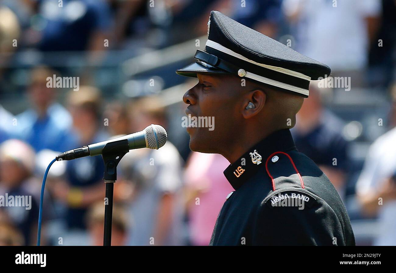 United States Army Staff Sgt. Jeremy Gaynor sings the national anthem ...