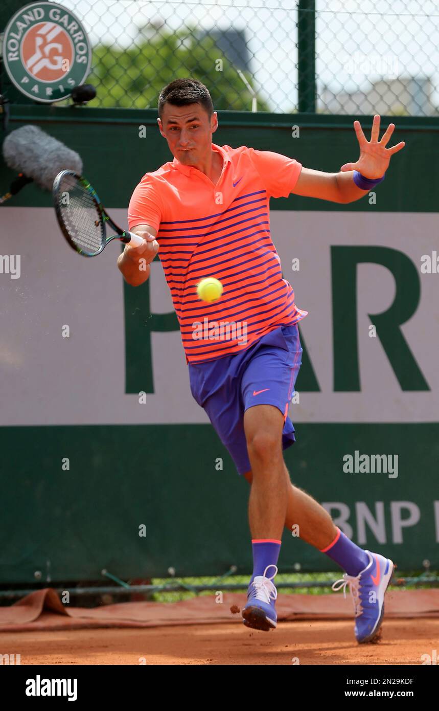 Australia's Bernard Tomic returns the ball to Italy's Luca Vanni during ...