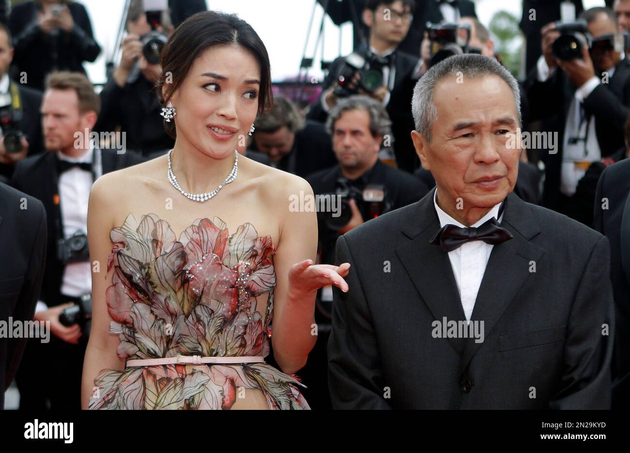 Actress Shu Qui, and director Hou Hsia-Hsien, pose for photographers ...