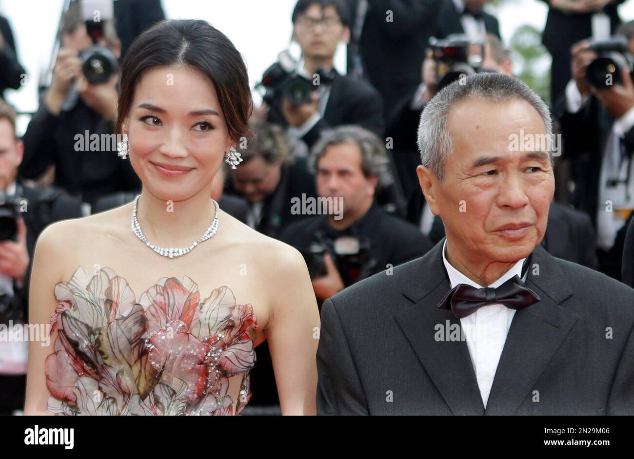 Actress Shu Qui, and director Hou Hsia-Hsien, pose for photographers ...