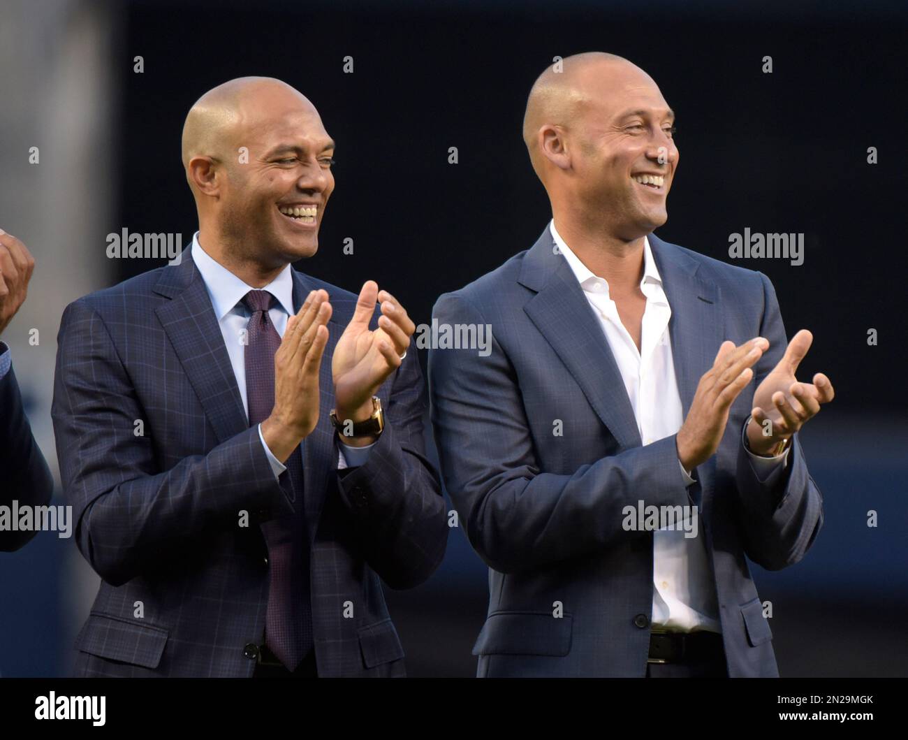 New York Yankees' Mariano Rivera, left, and Derek Jeter applaud as the ...