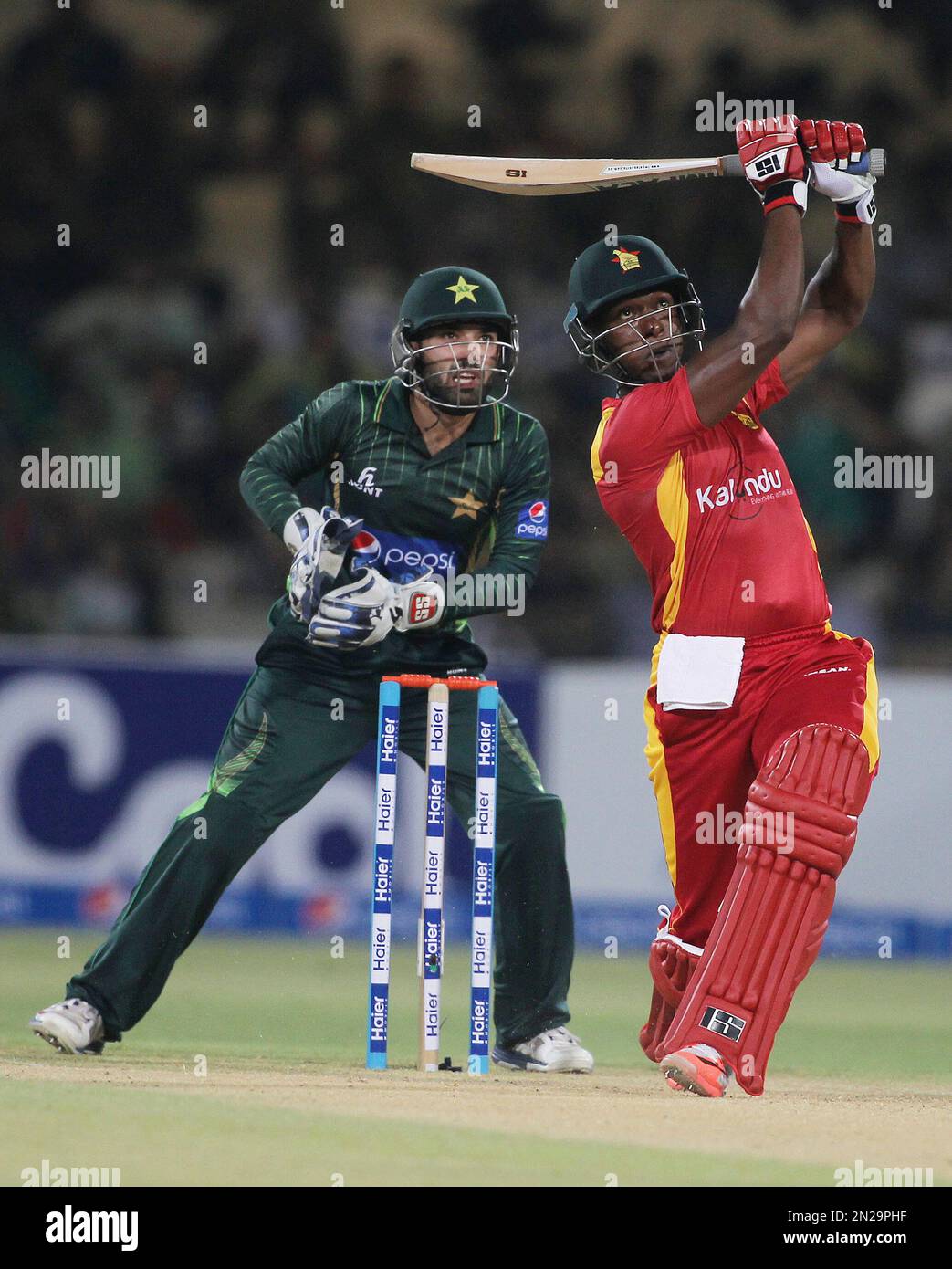 Zimbabwe's Vasimuzi Sibanda hits boundary as Pakistani wicketkeeper ...