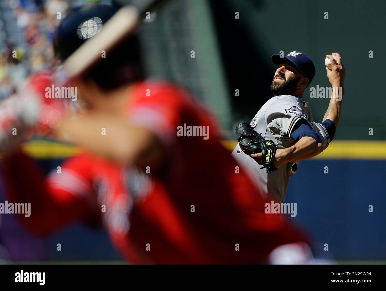 Milwaukee Brewers starting pitcher Mike Fiers, right, throws to Atlanta ...