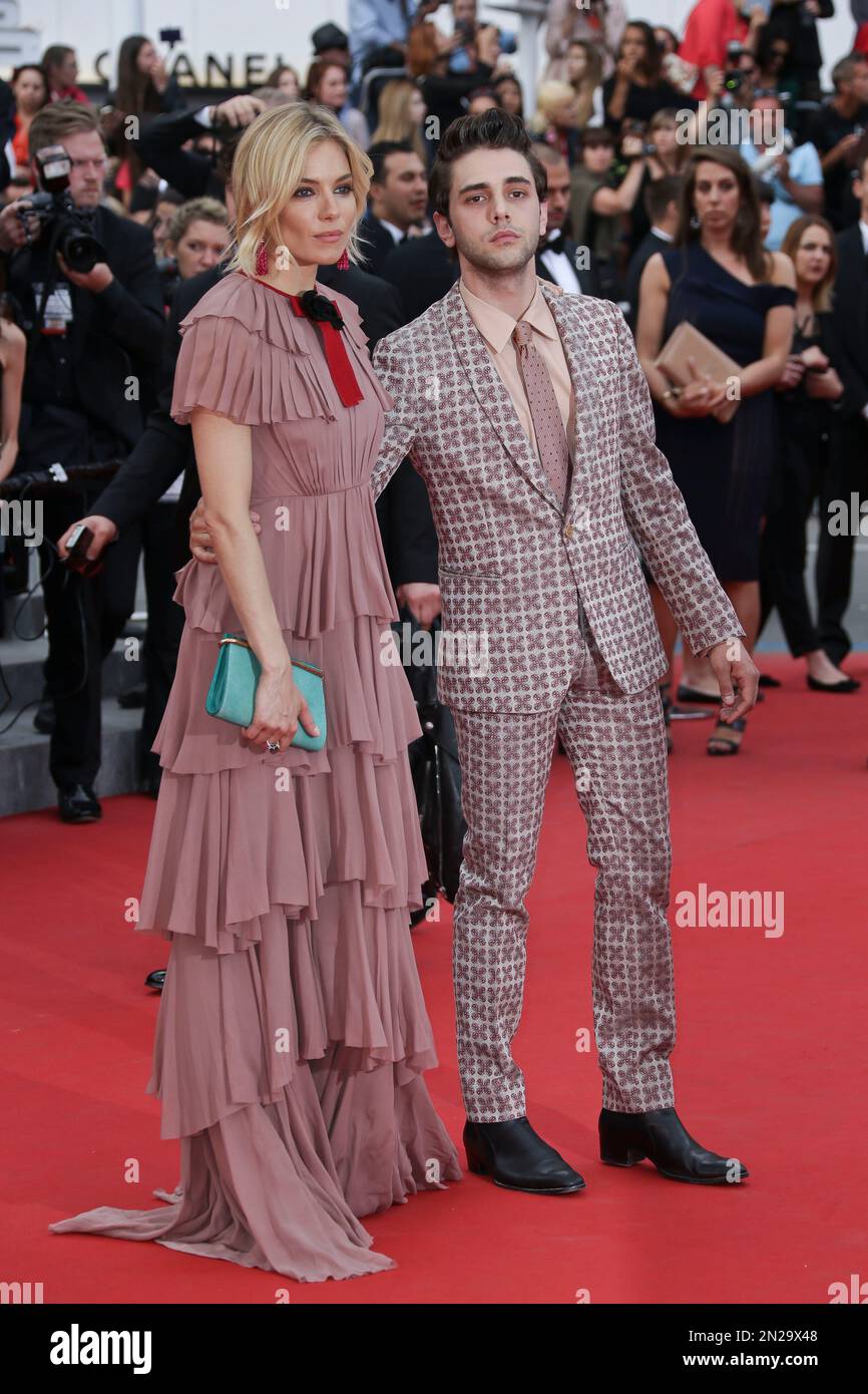 Sienna Miller and Xavier Dolan pose for photographers upon arrival for ...