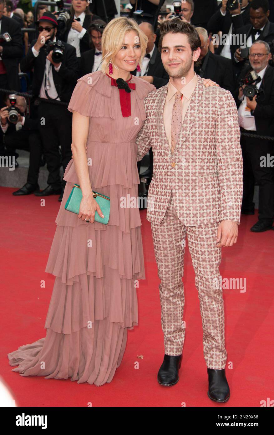 Sienna Miller and Xavier Dolan pose for photographers upon arrival for ...