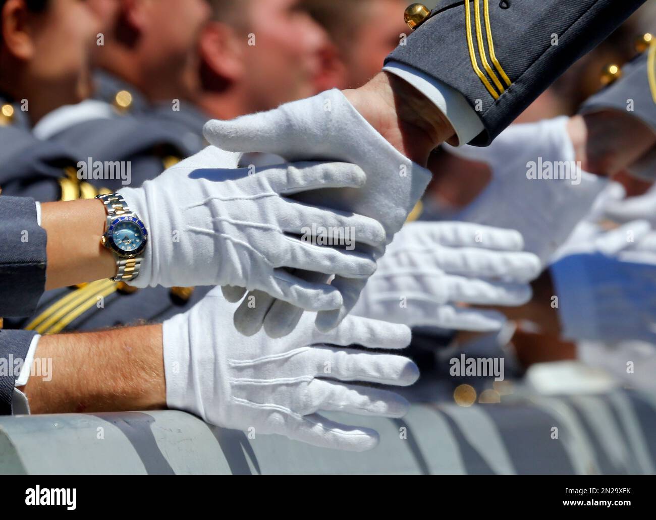 Cadets congratulate each other while receiving diplomas during a ...