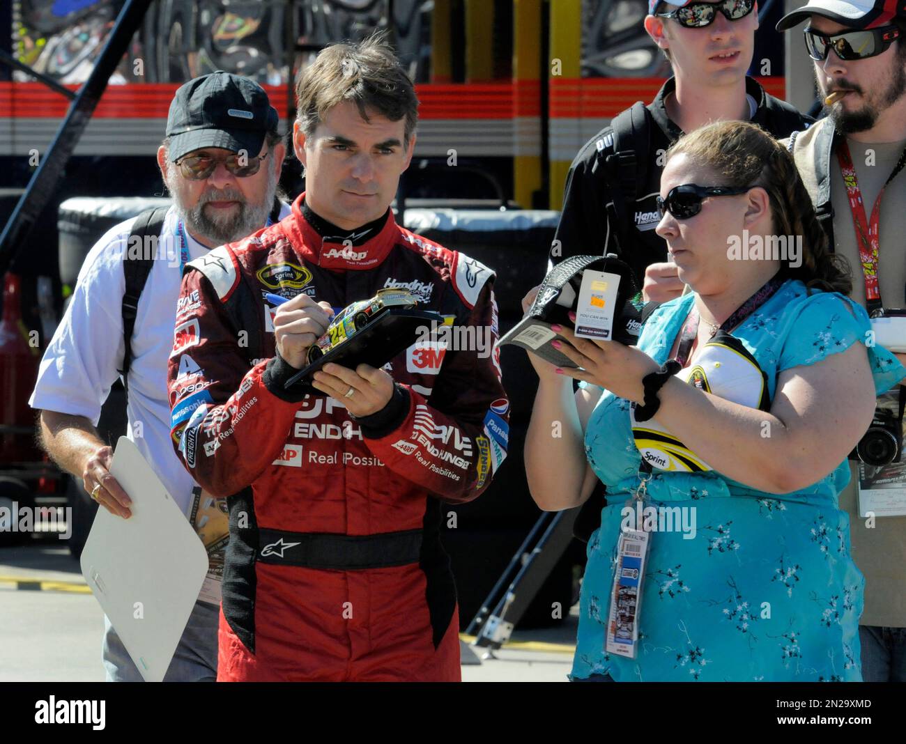 Jeff Gordon signs autographs before practice for Sunday's NASCAR Coca ...