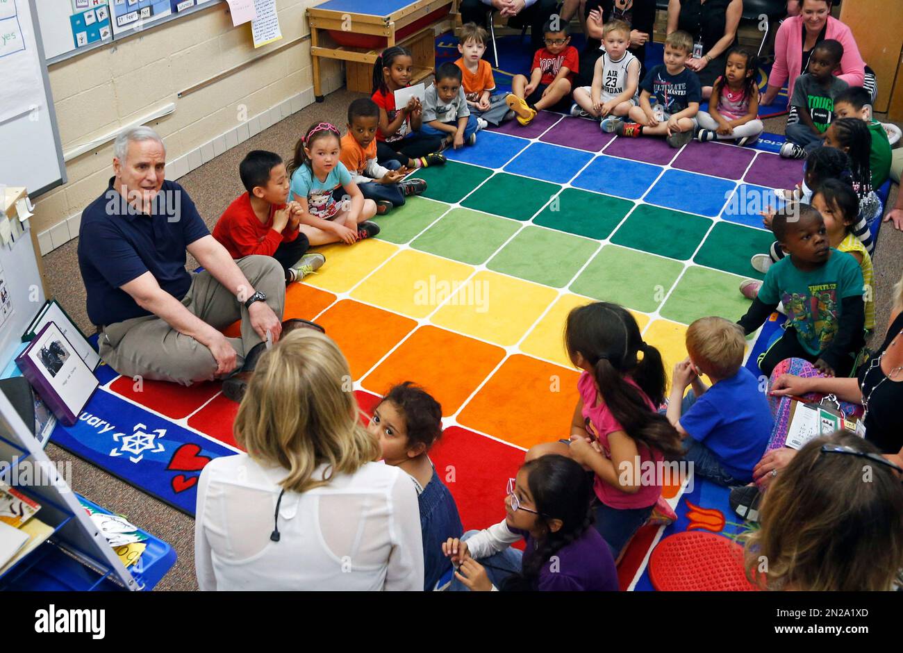 Minnesota Gov. Mark Dayton, left, joins the circle of preschoolers ...