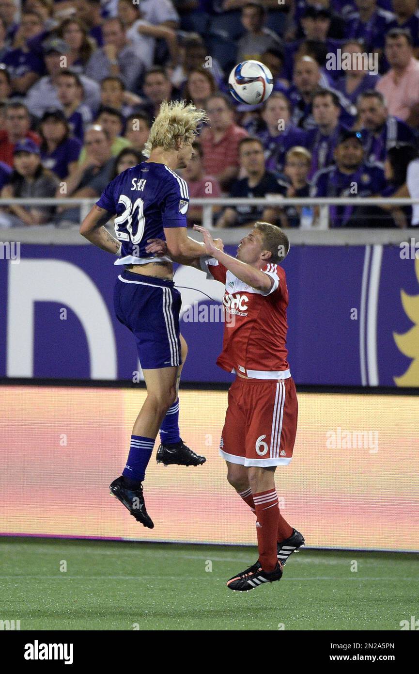 Orlando City midfielder Brek Shea (20) wins a header over New England ...
