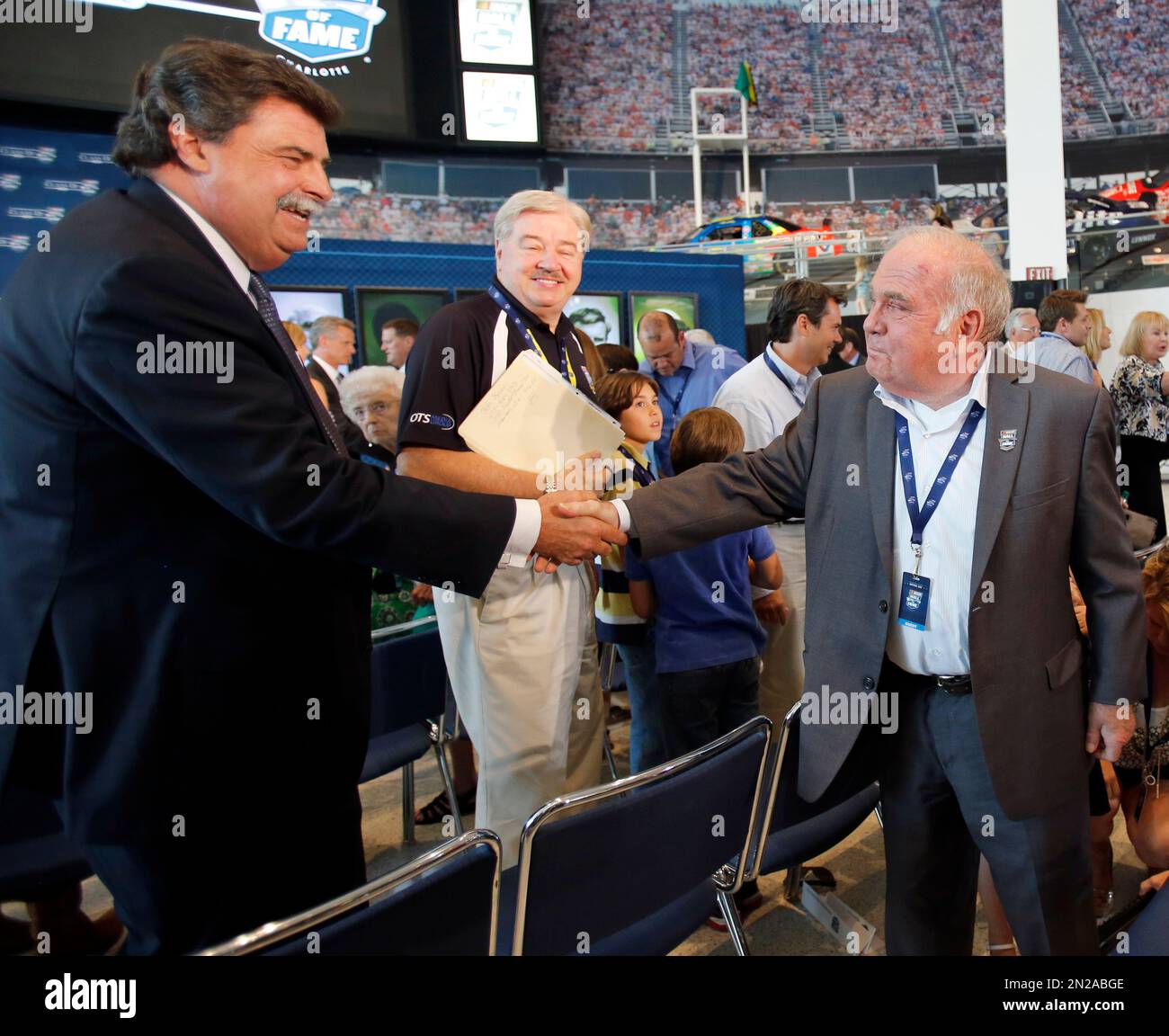 Jerry Cook, left, is congratulated by NASCAR vice-chairman Mike Helton ...
