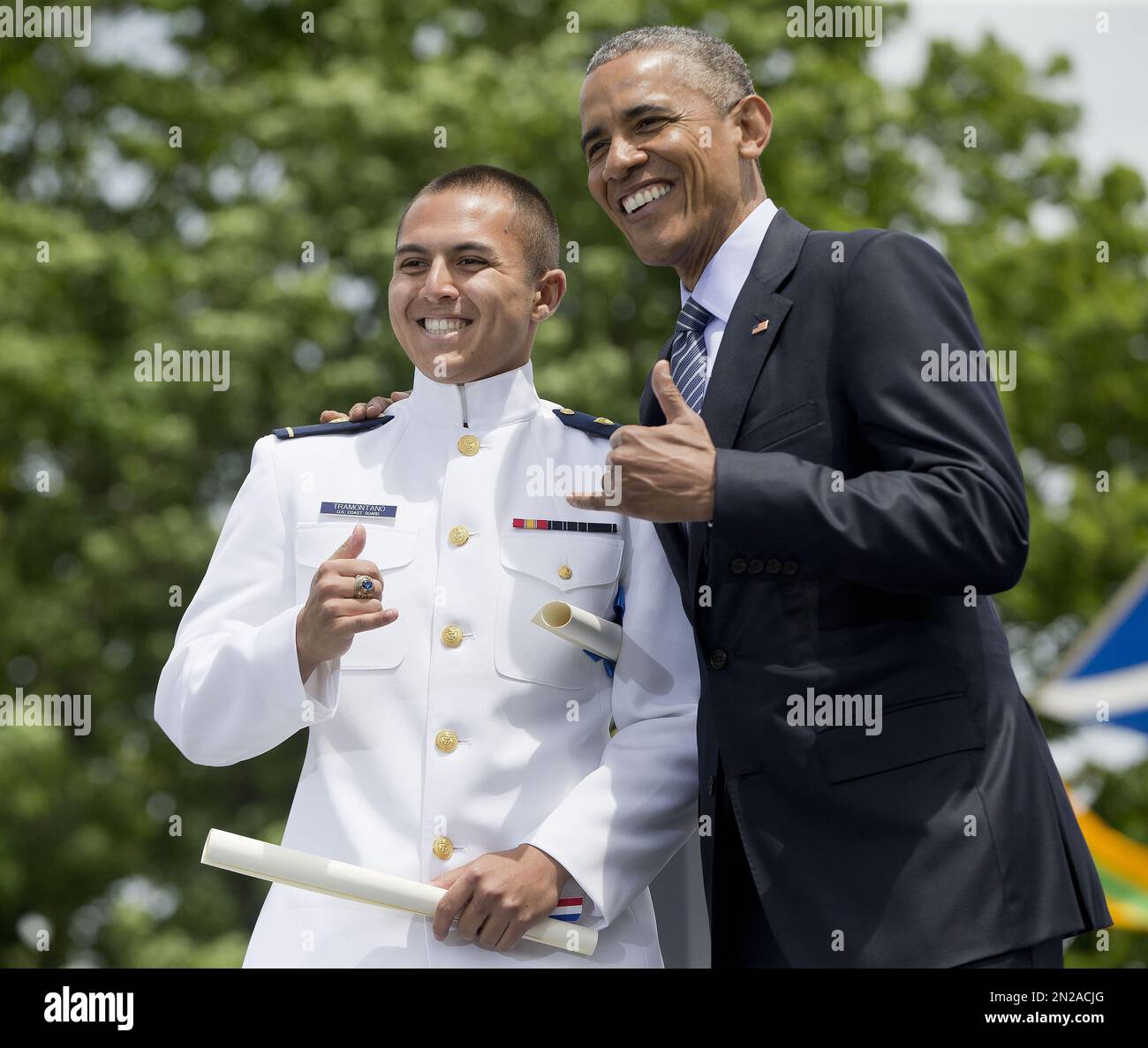 President Barack Obama makes the traditional Hawaiian "shaka" greeting ...
