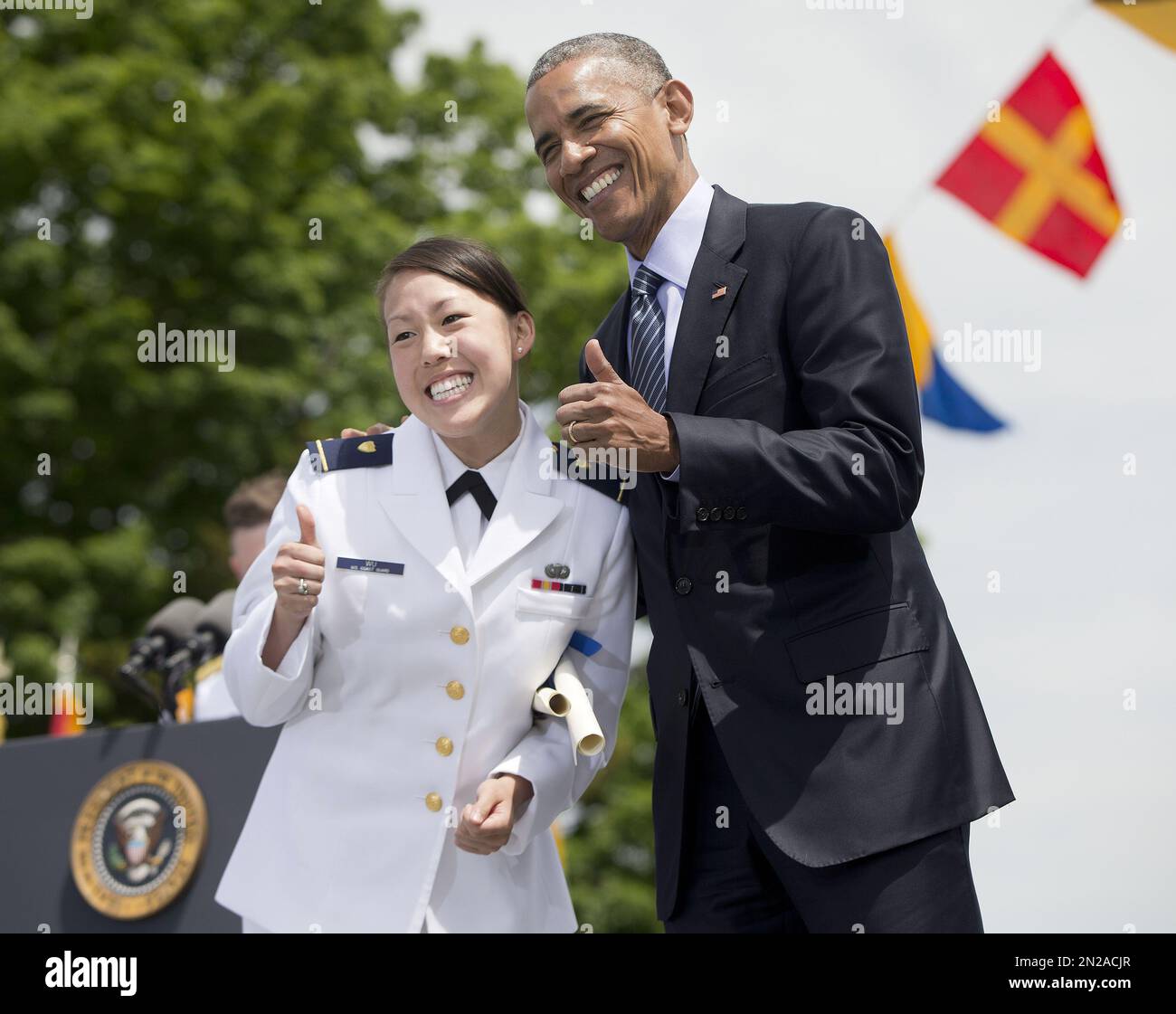 President Barack Obama and Ensign Ellie Wu strike a pose after she ...