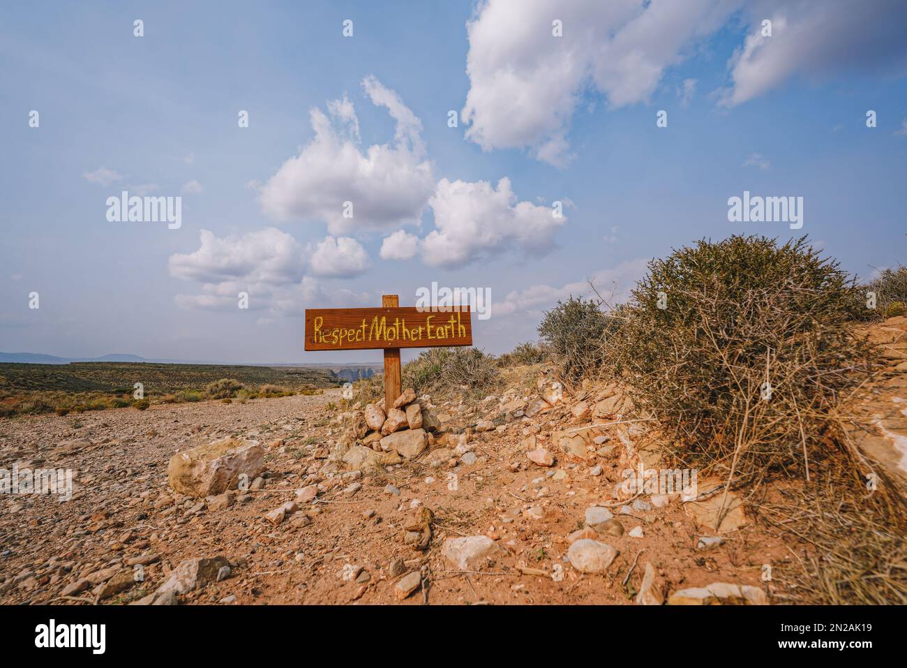 Respect Mother Earth poster in the middle of desert on unpaved road in ...