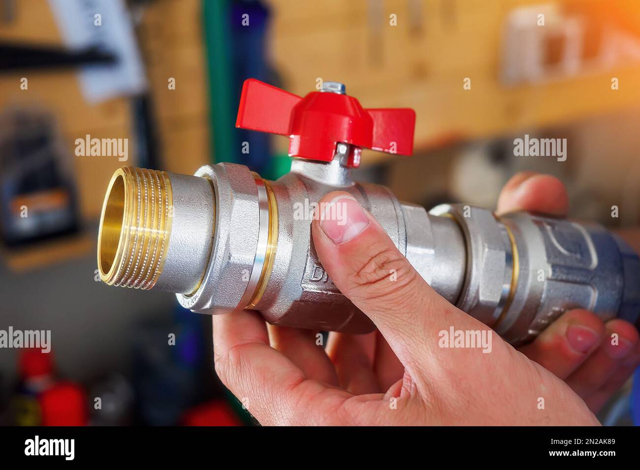 Man holding semi-rotating faucet for plumbing in his hand. Selection of ...