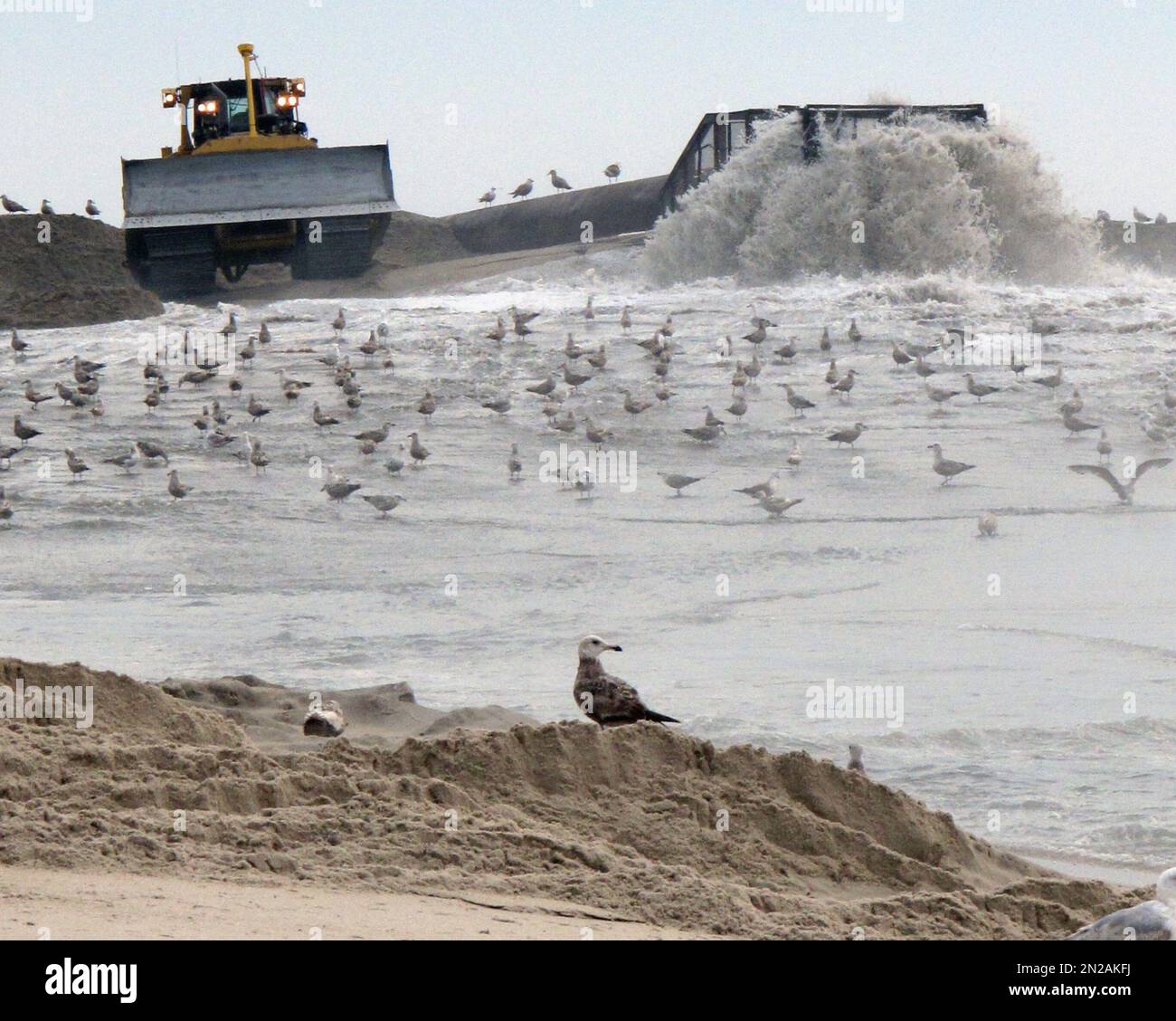 This May 18, 2015 photo shows a mixture of sand and water being pumped ...