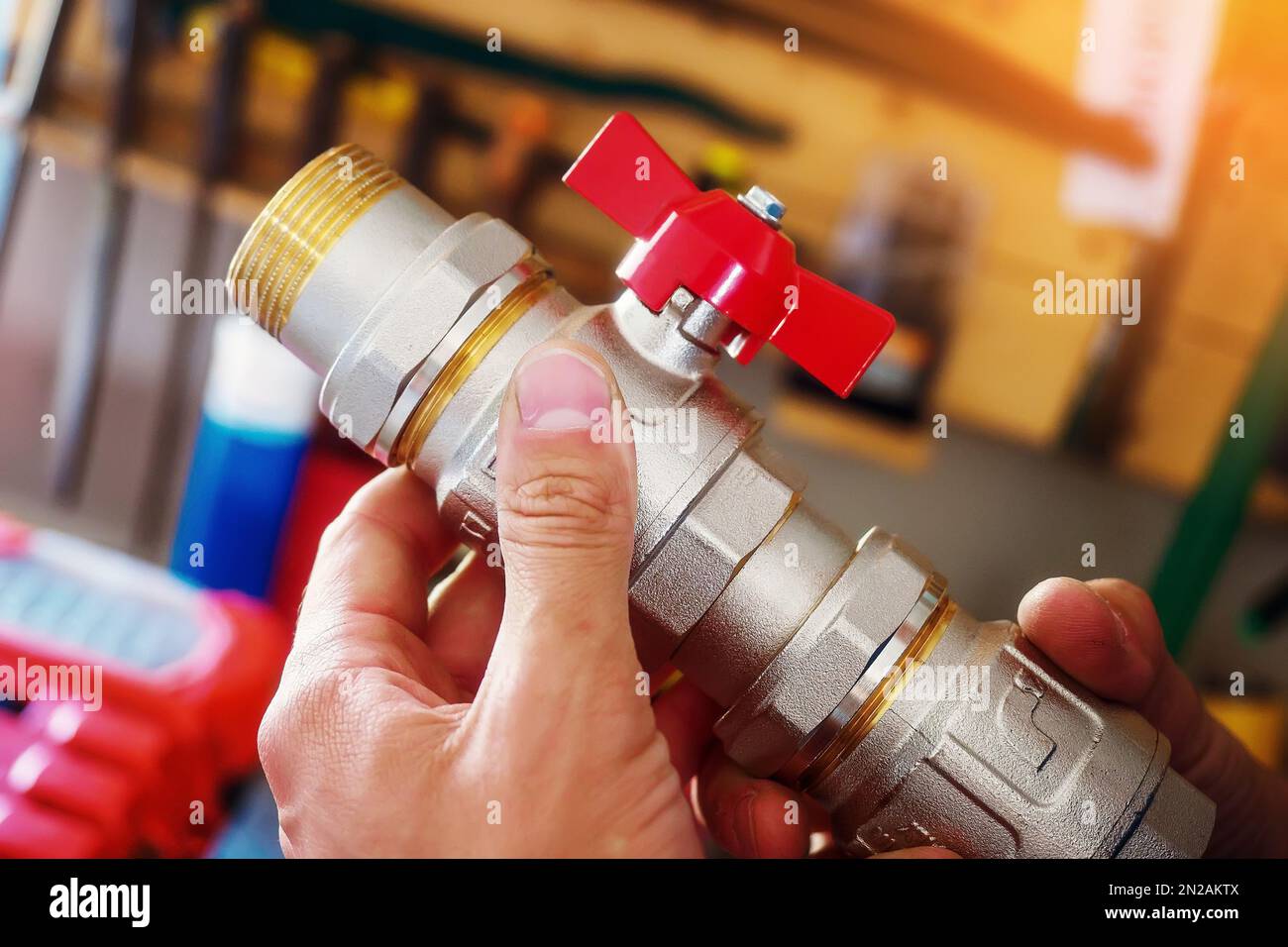Man holding semi-rotating faucet for plumbing in his hand. Selection of ...