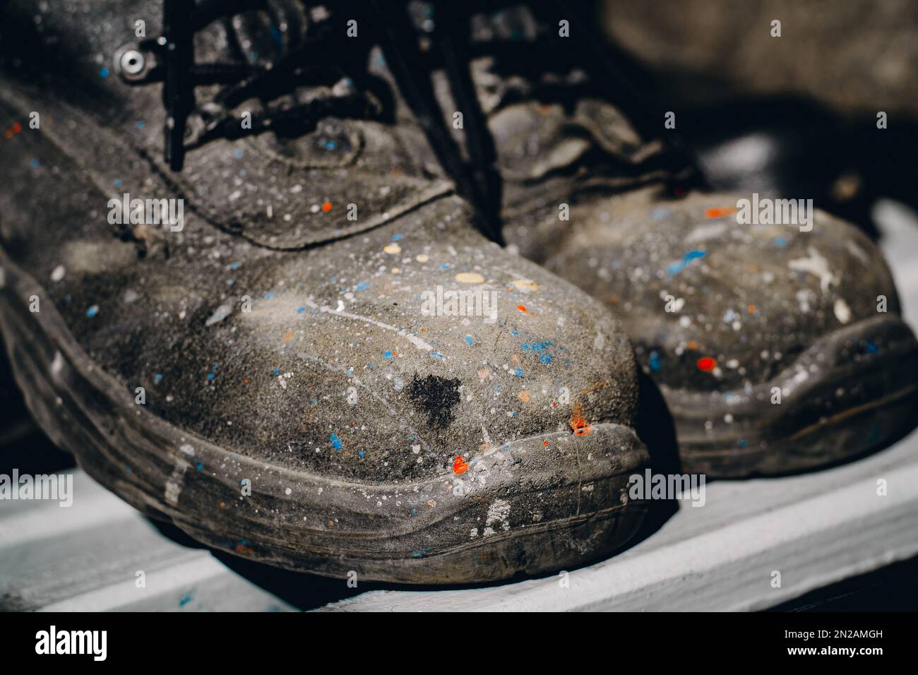 Working shoes. Old paint-stained boots and worn-out industrial painter ... Working shoes. Old paint-stained boots and worn-out industrial painter ...