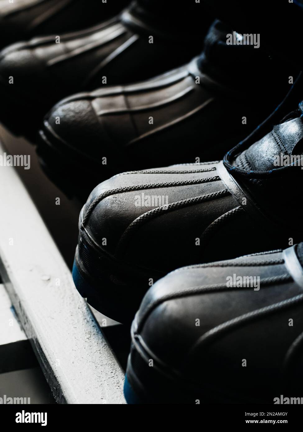 Warm work shoes. Workers' winter industrial boots stand in row in ...