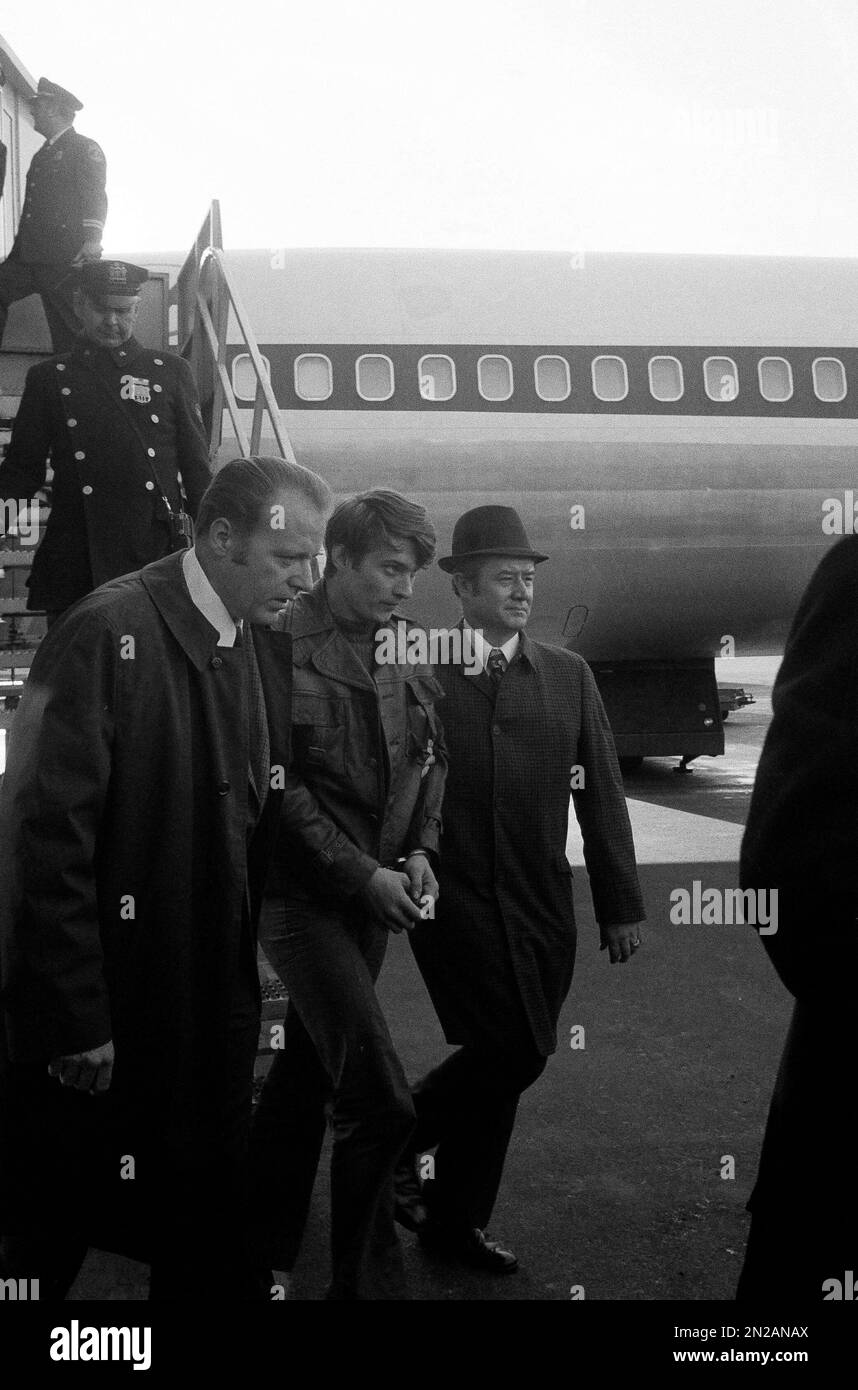 John Wayne Wilson, center, is escorted by plainclothesmen from the ...
