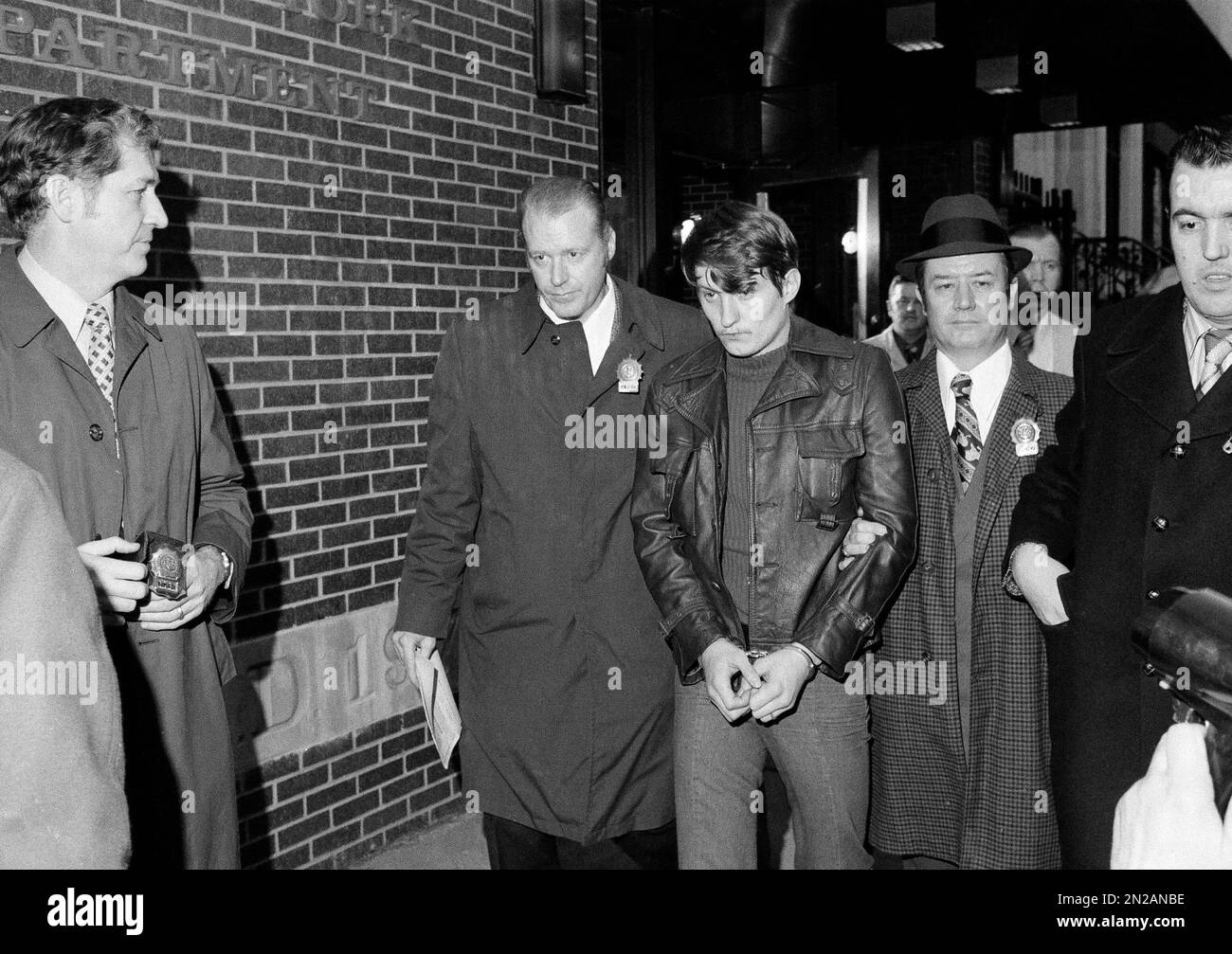 John Wayne Wilson, center, is escorted by plainclothesmen from the 20th ...