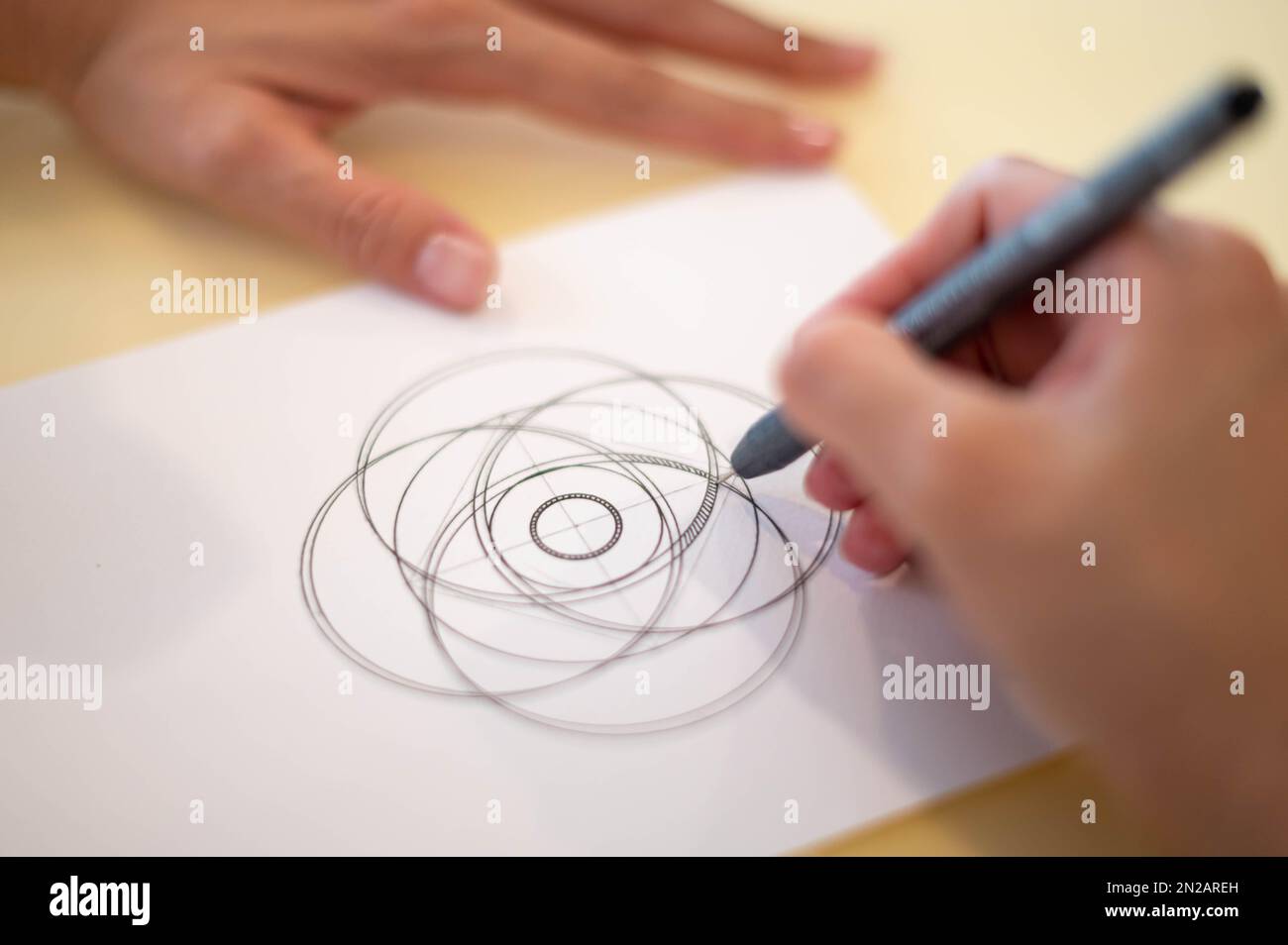 Female hand using a black magic pen preparing to draw and sketch the ...