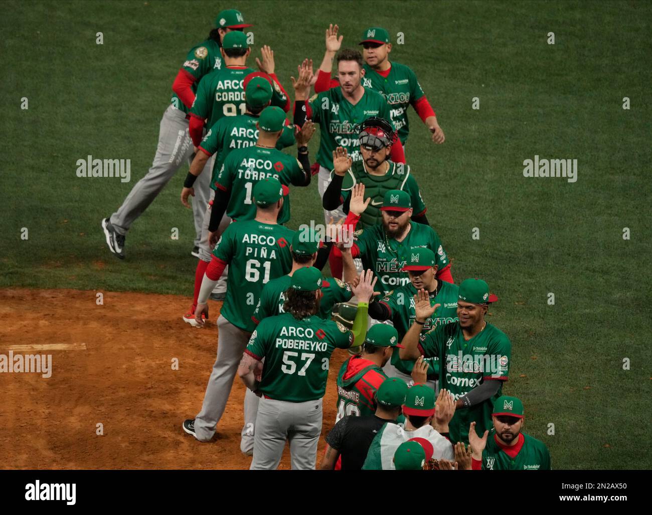 Mexico's players celebrate after defeating Venezuela 7-0 during a ...