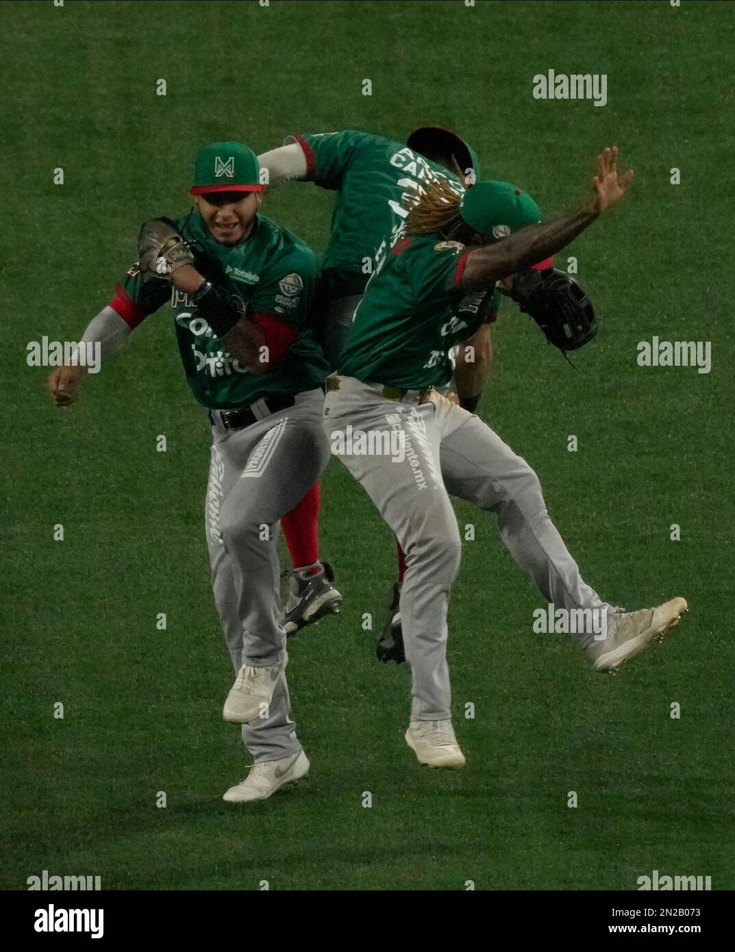 Mexico's players celebrate after defeating Venezuela 7-0 during a ...