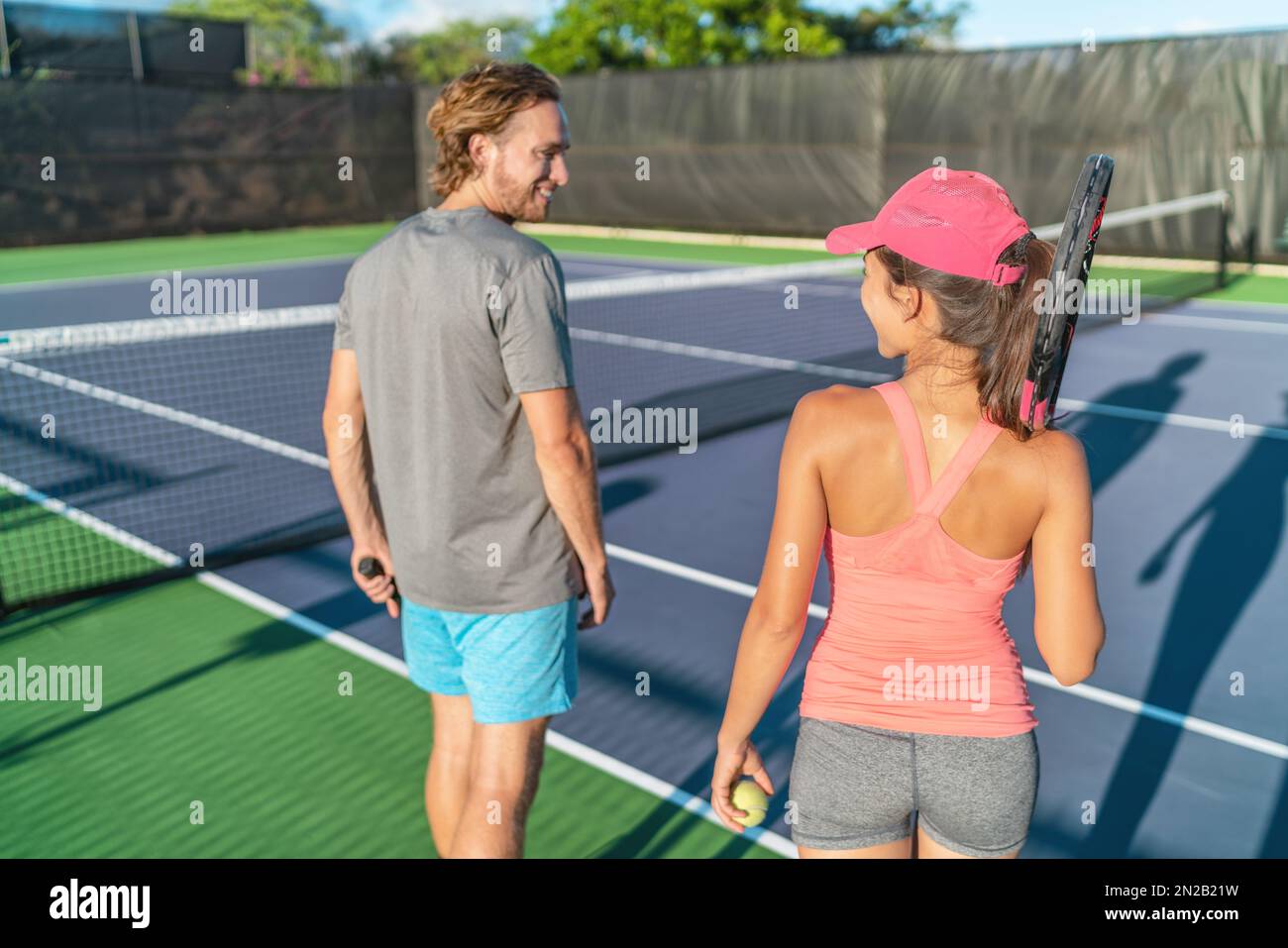 Tennis court players couple playing outside recreational activity for ...