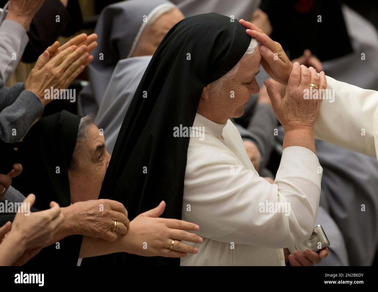Pope Francis blesses a nun as he arrives for an audience with clergy of ...