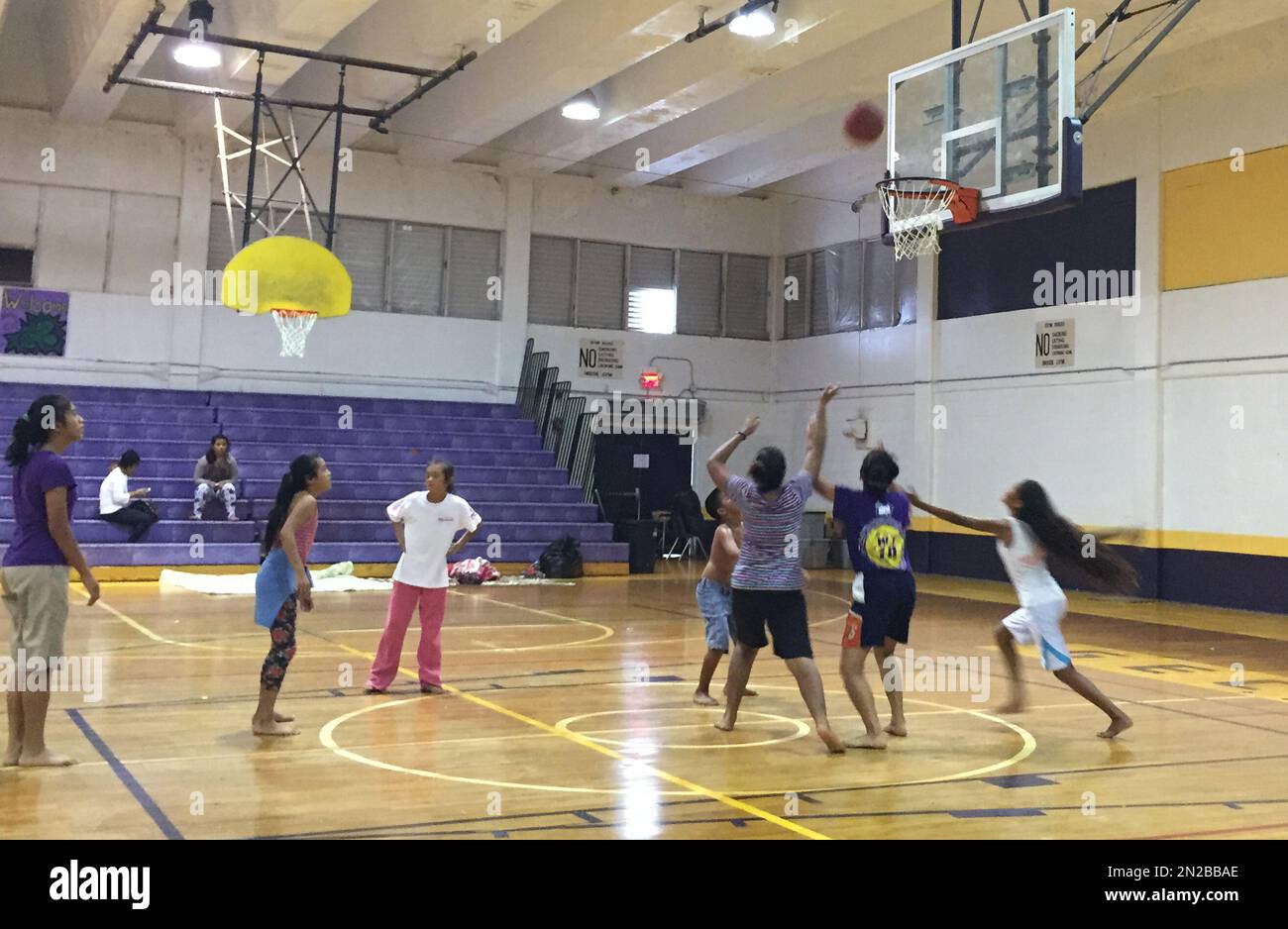 Children play basketball at the emergency shelter at George Washington ...
