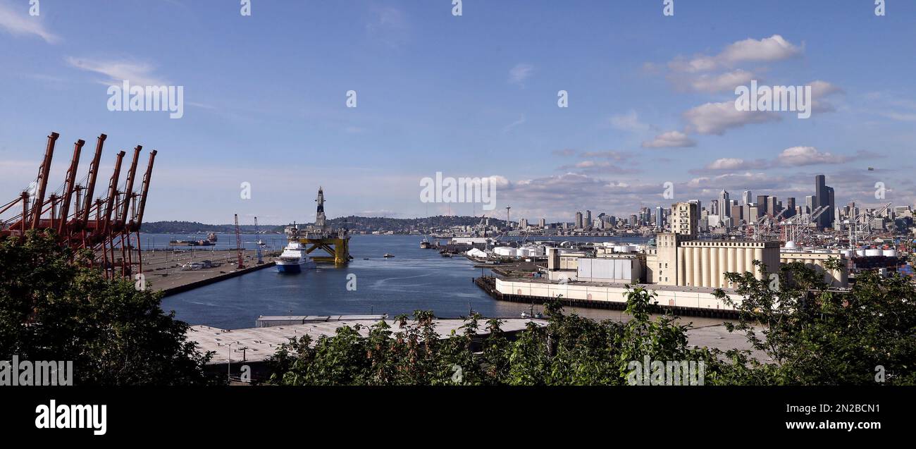 The oil drilling rig Polar Pioneer, back, sits at a dock with the ...