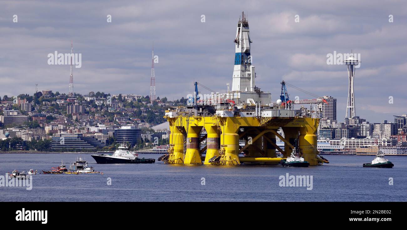 A small flotilla of kayakers and other protest boats follow as the oil ...