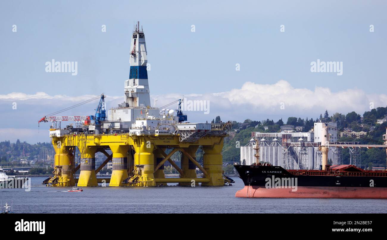 The oil drilling rig Polar Pioneer, left, dwarfs a grain freighter ...