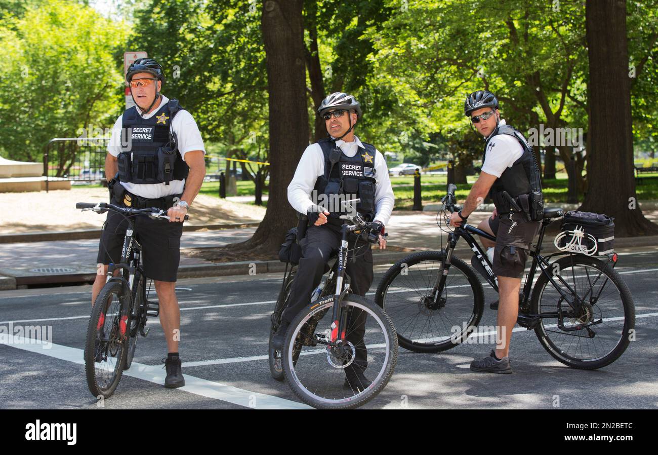 A uniformed Secret Service Police officer patrol on bikes near the ...