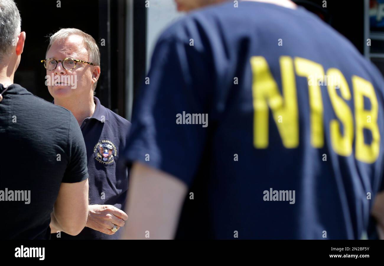 National Transportation Safety Board member Robert Sumwalt, left, stops ...