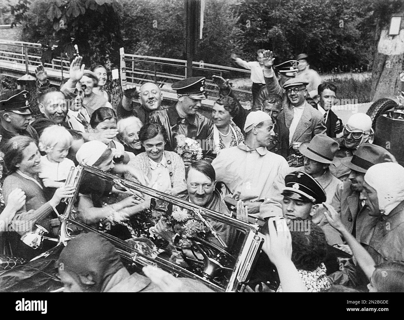 German peasants crowd around Adolf Hitler's car to get a good view of ...